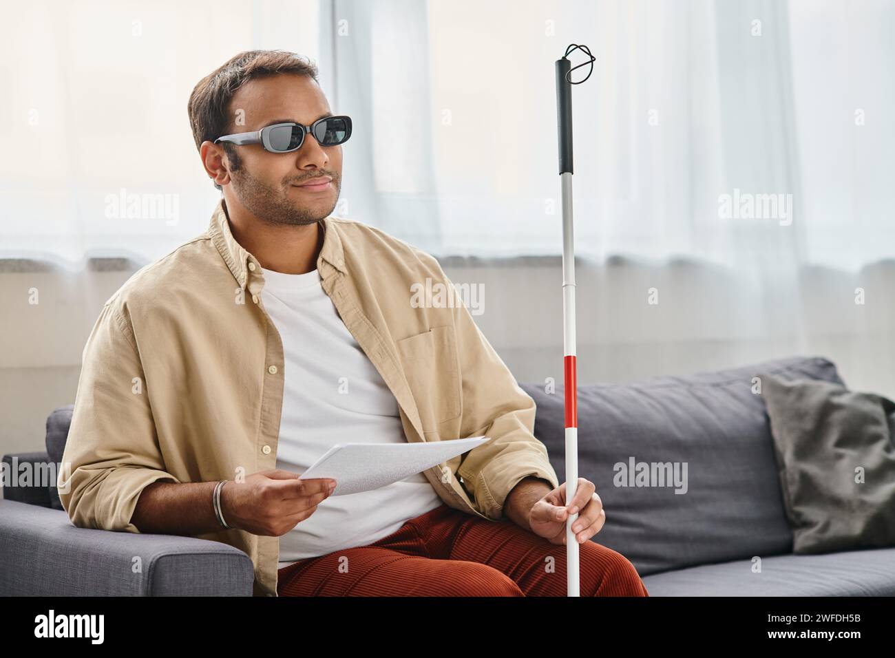 jolly indian man with visual impairment with glasses and walking stick ...
