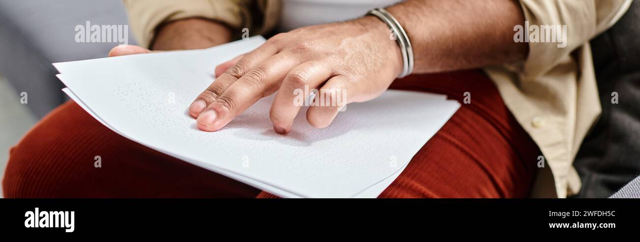 cropped view of indian disabled man in casual attire sitting and ...