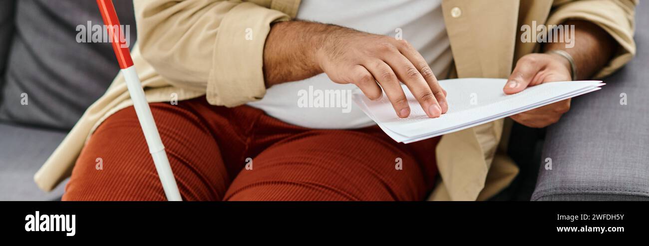 cropped view of indian blind man in comfy clothing sitting on sofa and ...