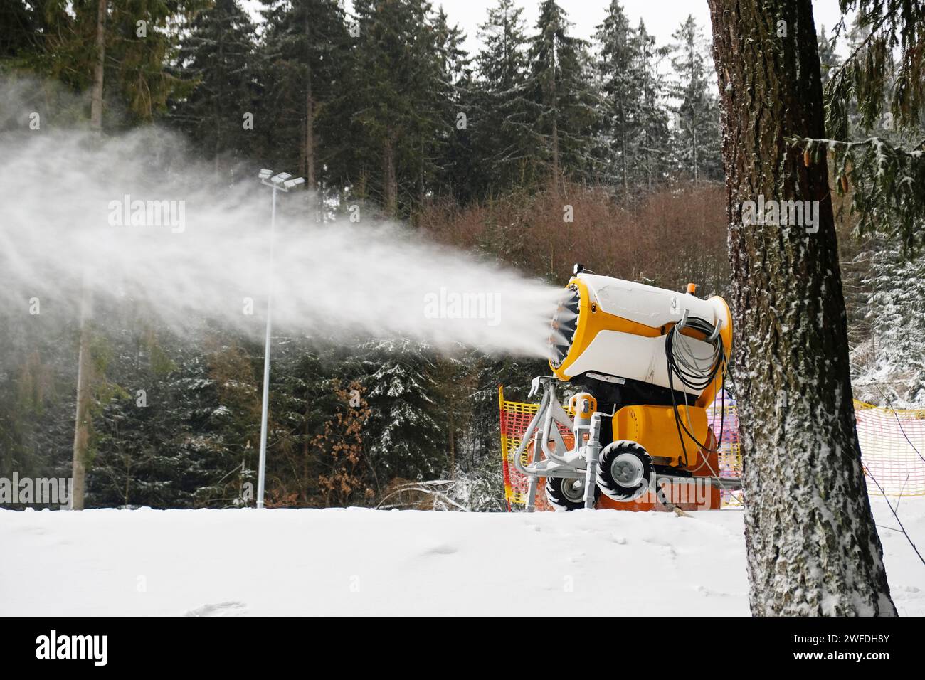 Snow cannon makes artificial snow. Snowmaking systems sprays water to ...