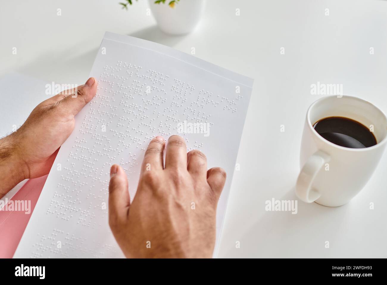 cropped view of indian man with blindness in casual attire with coffee ...