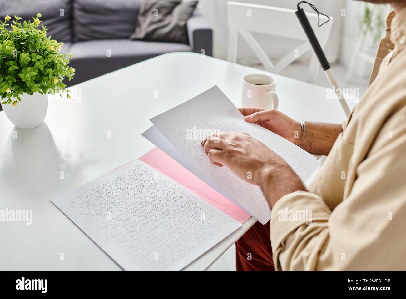 cropped view of indian disabled man in casual attire with walking stick ...