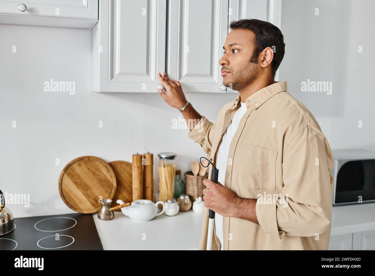 good looking indian disabled man in casual attire with walking stick ...
