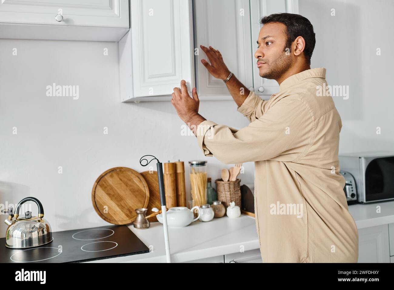 handsome indian disabled man in casual attire with walking stick ...