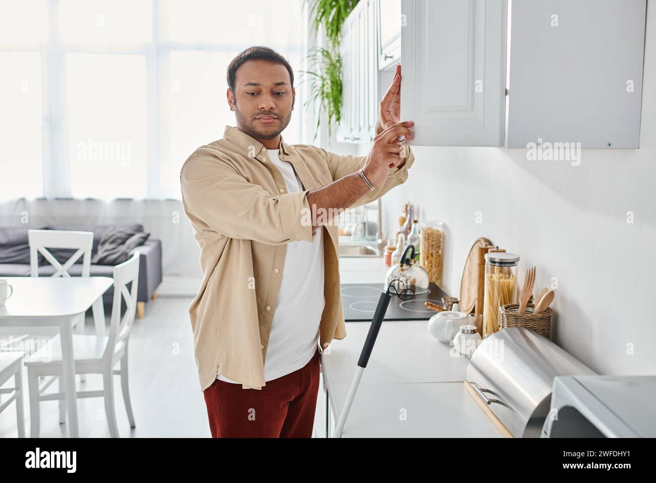 attractive indian disabled man in casual attire with walking stick ...