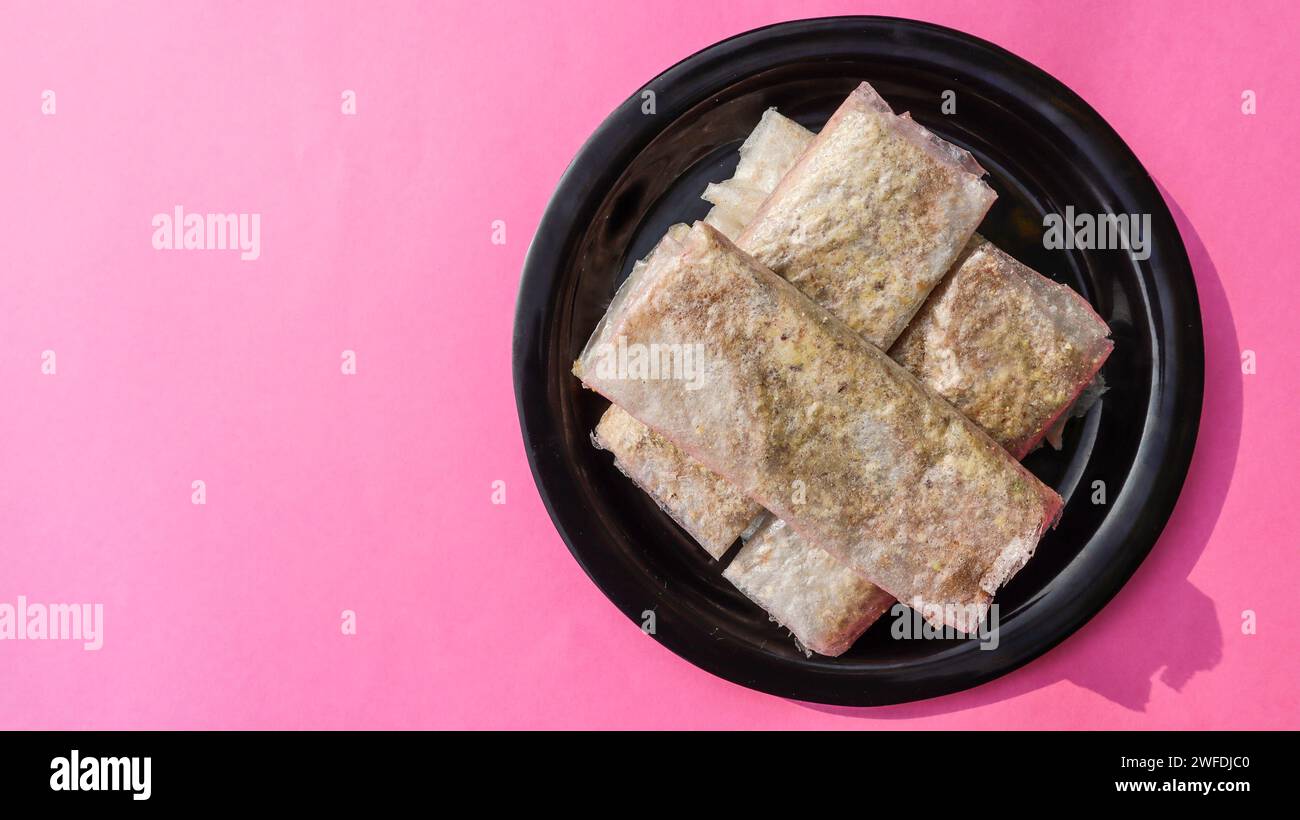 Traditional Andhra sweet Pootharekulu made from paper thin sheet made ...