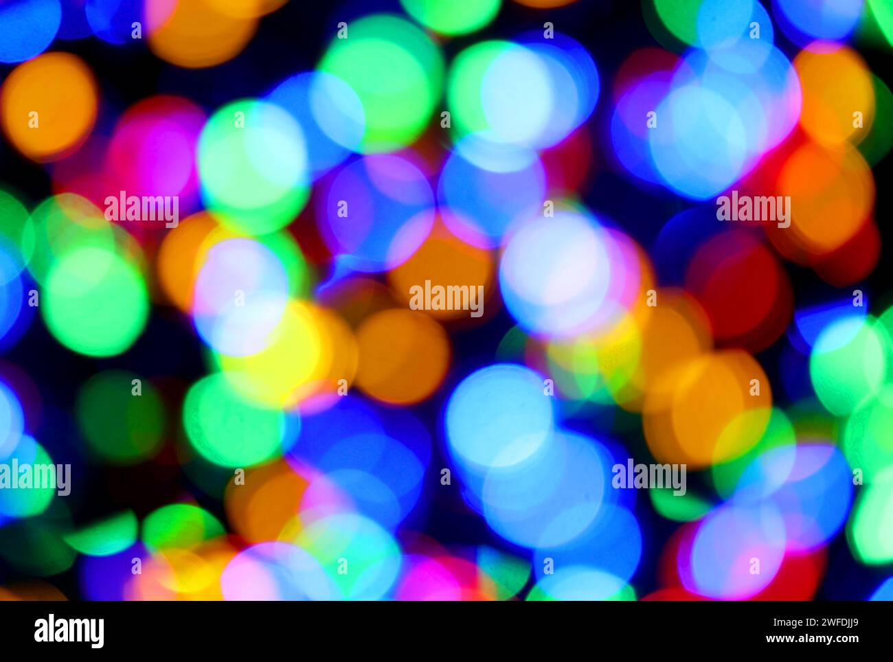 intentionally blurred background of many colorful lights of many colors ...