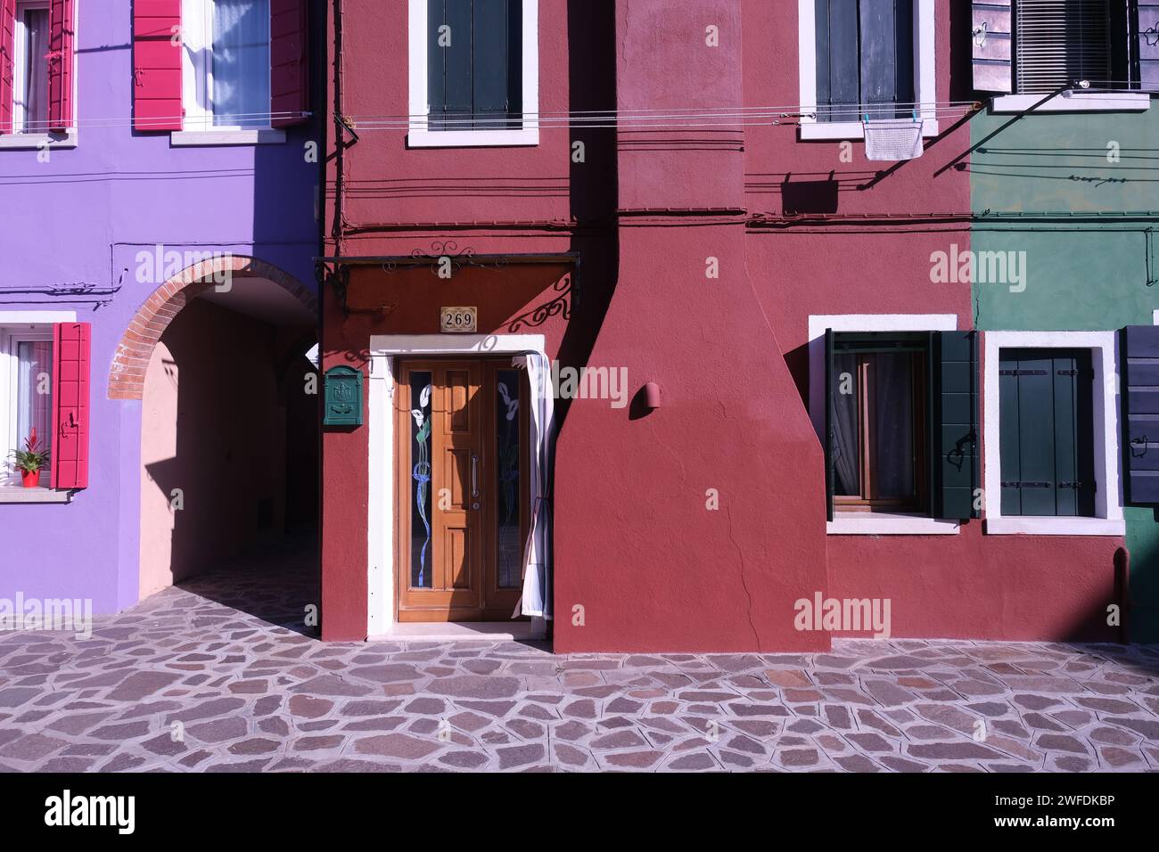 The colorful entrances to houses on the island of Burano near venice ...
