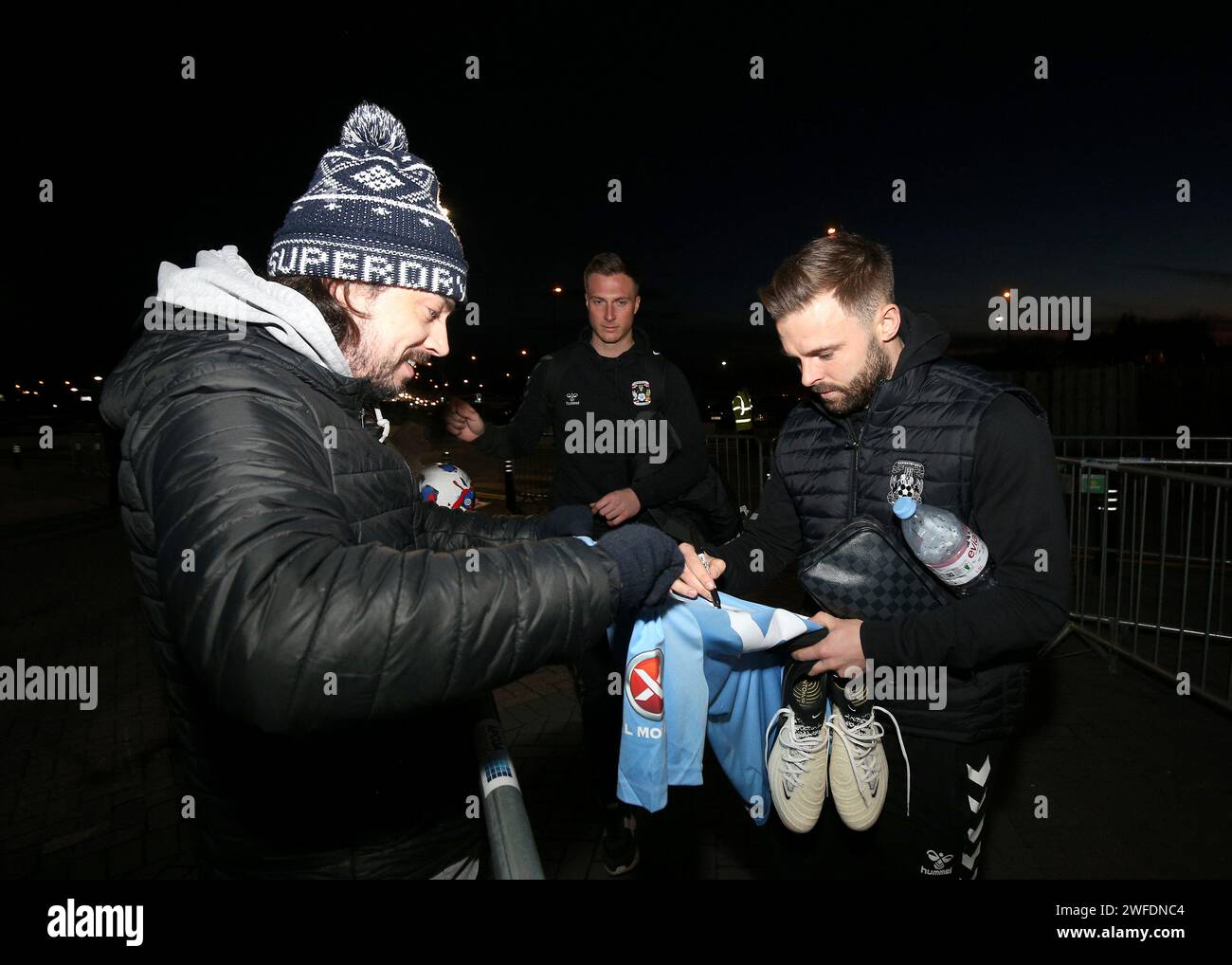 Coventry City's Matthew Godden (right) signs an autograph for a fan ...
