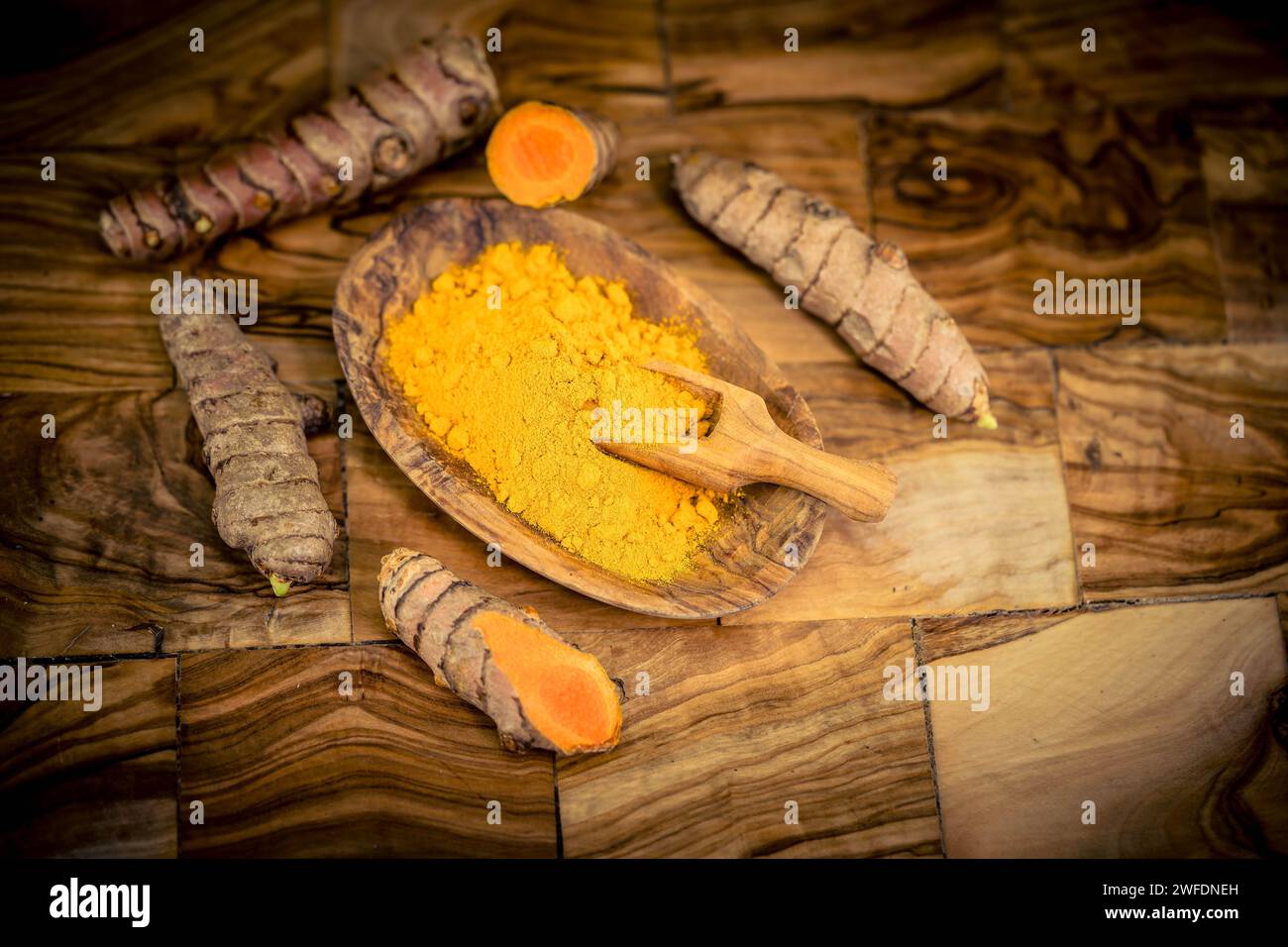 Turmeric Curcuma longa the yellow spice on olive wood Stock Photo - Alamy