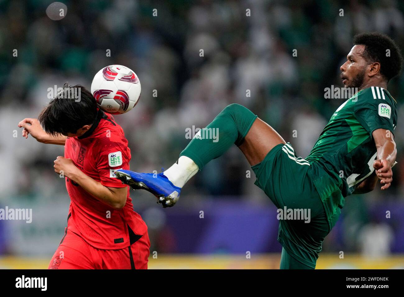 Saudi Arabia's Ali Al Bulayhi, right, duels for the ball with South ...