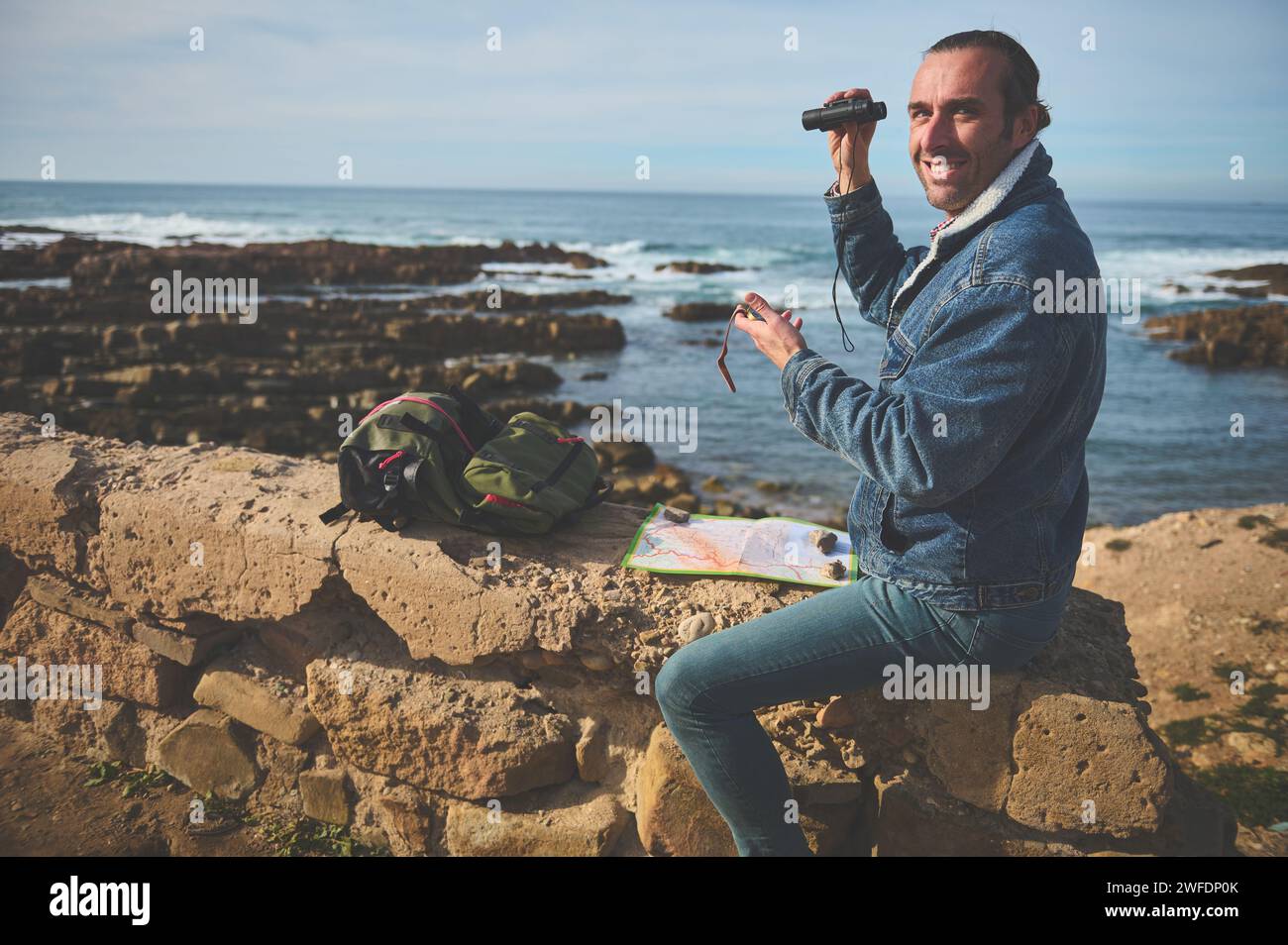 Man using compass on map hi-res stock photography and images - Alamy
