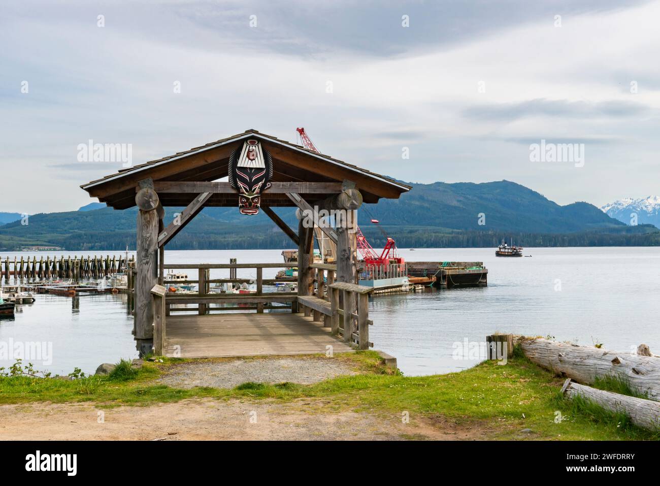 A pier on the shoreline of Yalis (Alert Bay) with views of the ...