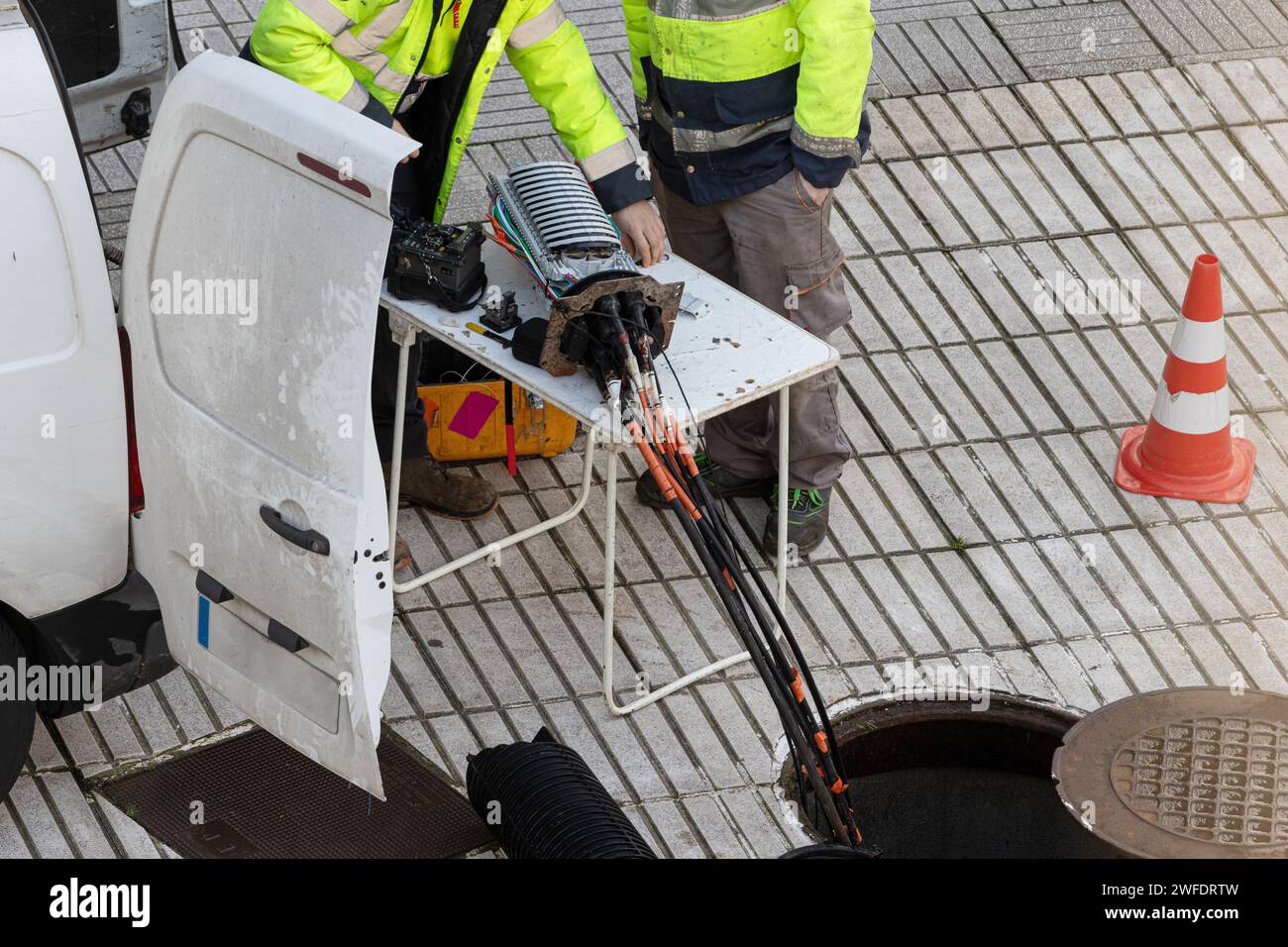 Technicians workers repairing fiber optic cable lines and checking on a ...