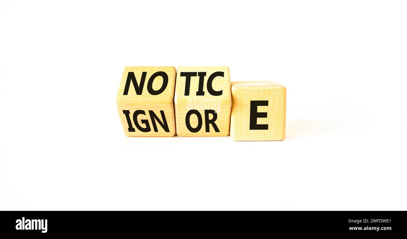 Notice or ignore symbol. Concept word Notice or Ignore on wooden cubes ...