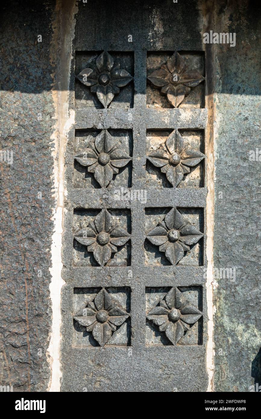 Carvings of floral patterns on the stone walls of the ancient ...