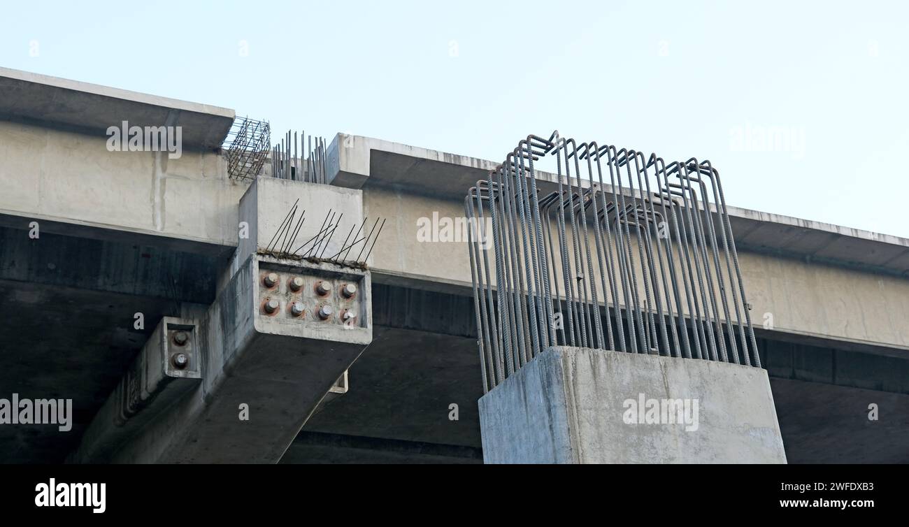 Round iron reinforcing bars or rebars jutting out of unfinished pillars ...