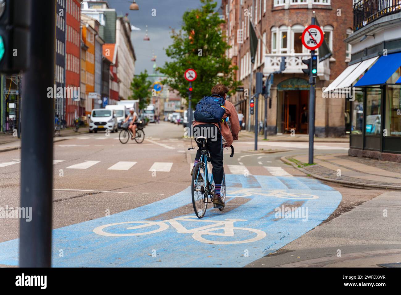 Copenhagen, Denmark - July 17, 2023: Man riding a bicycle on a cycle ...