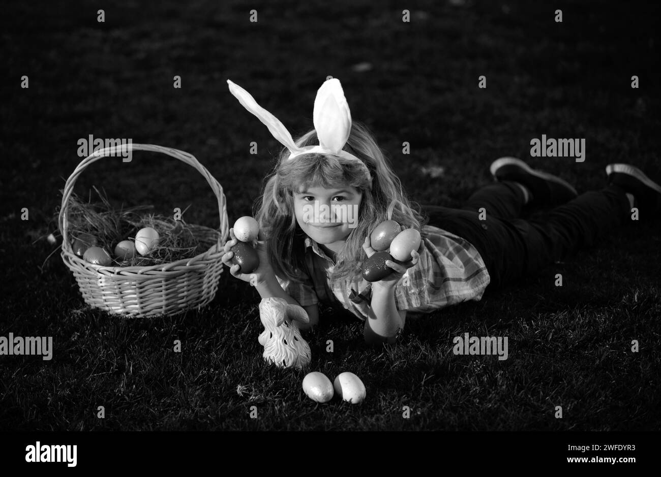 Child bunny boy with rabbit bunny ears. Kids boy hunting easter eggs in ...