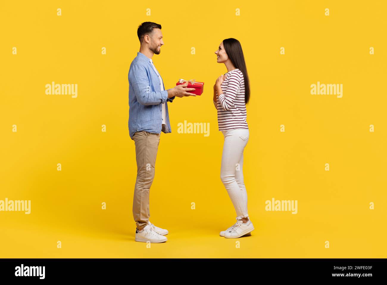 Man presenting to woman red gift box hi-res stock photography and ...