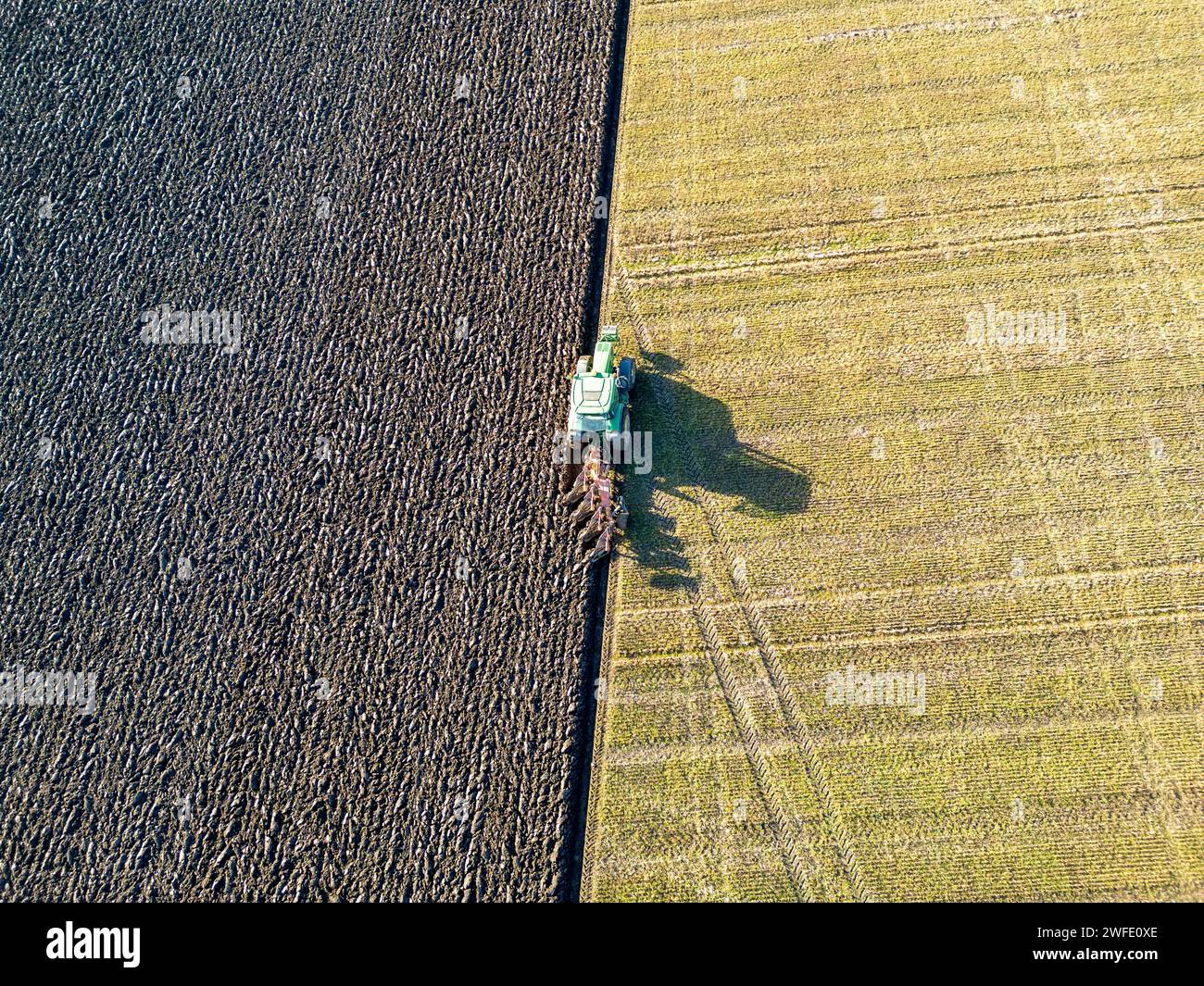 Aerial drone view of a tractor ploughing a field, Linlithgow, West ...