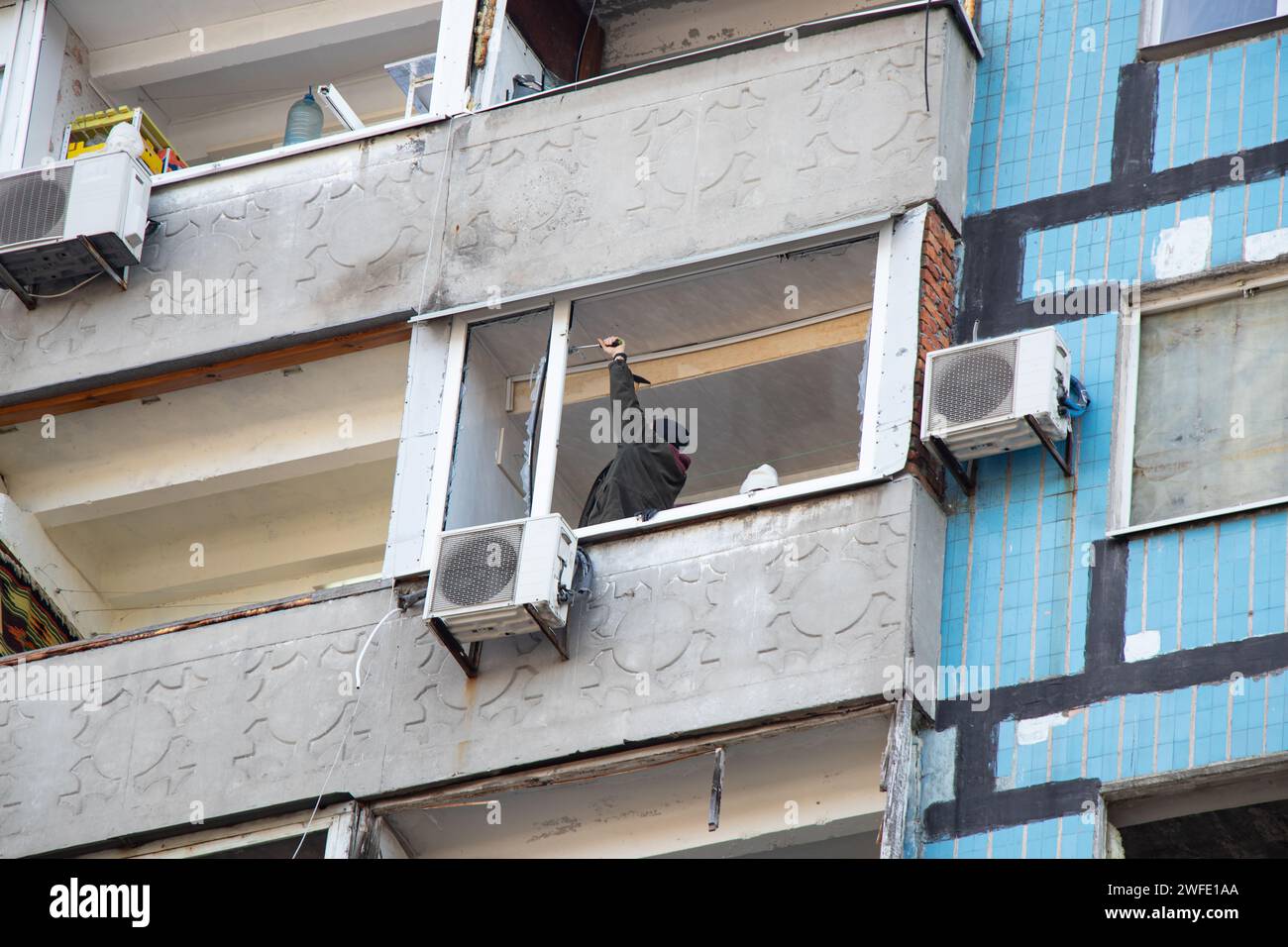 A man repairs a window after an explosion in the city of Dnepr in ...