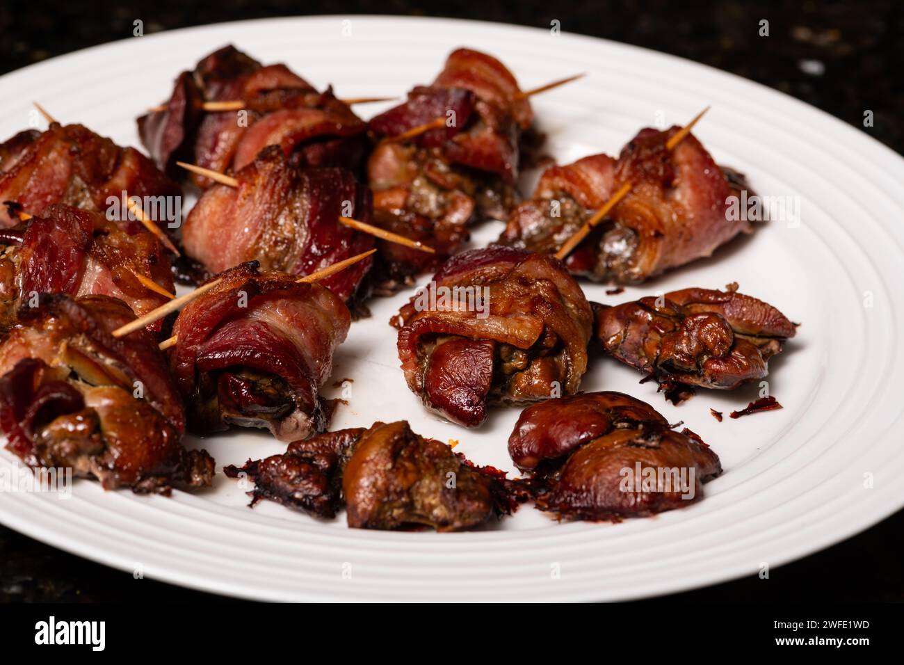 Cooked chicken liver wrapped with bacon. Roasted liver kebabs with on a ...