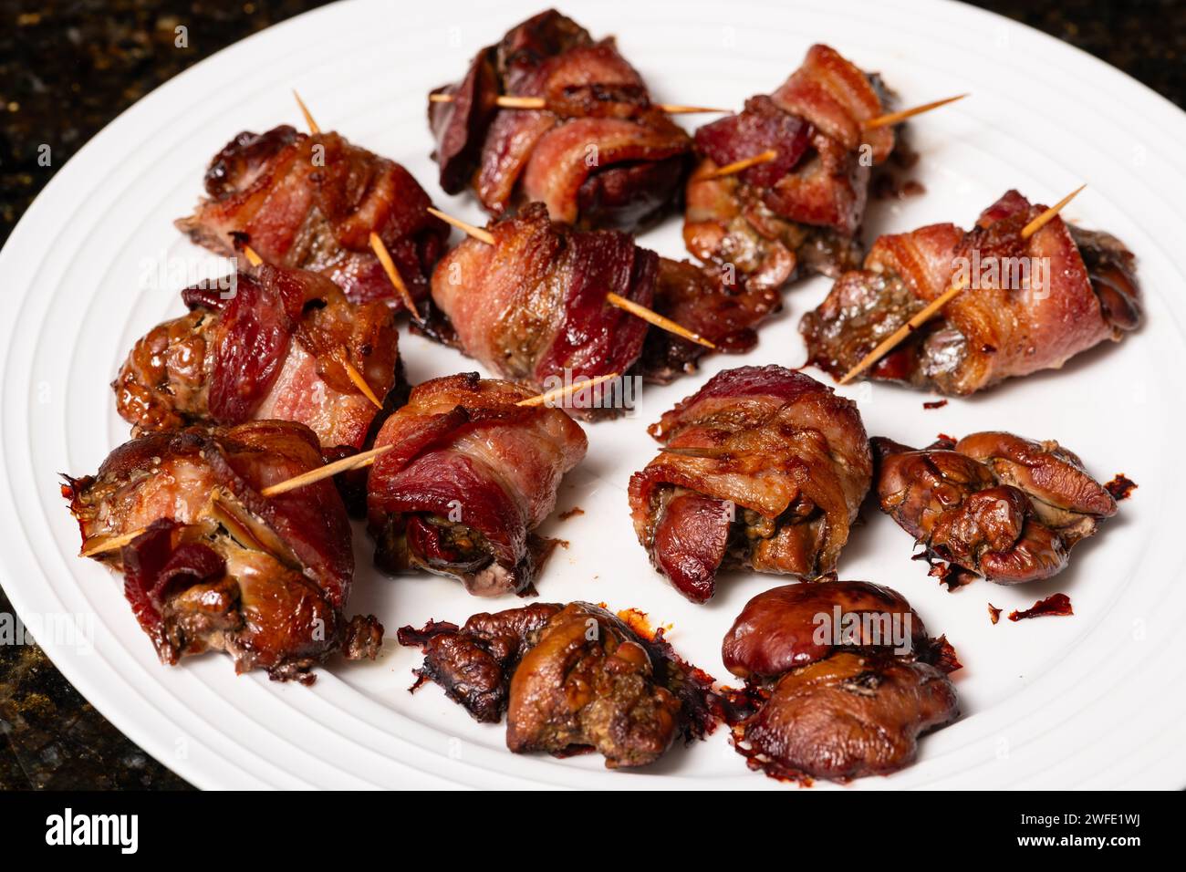 Cooked chicken liver wrapped with bacon. Roasted liver kebabs with on a ...