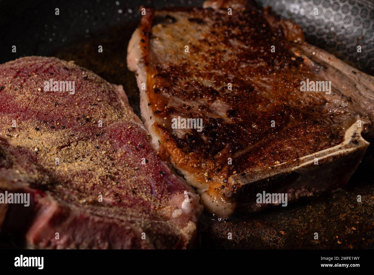 Beef steak cooking at high temperature in a frying pan Stock Photo - Alamy