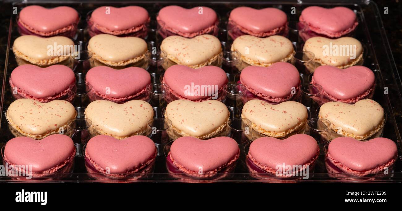 Traditional french baked pastry, heart shaped macarons with vanilla and ...