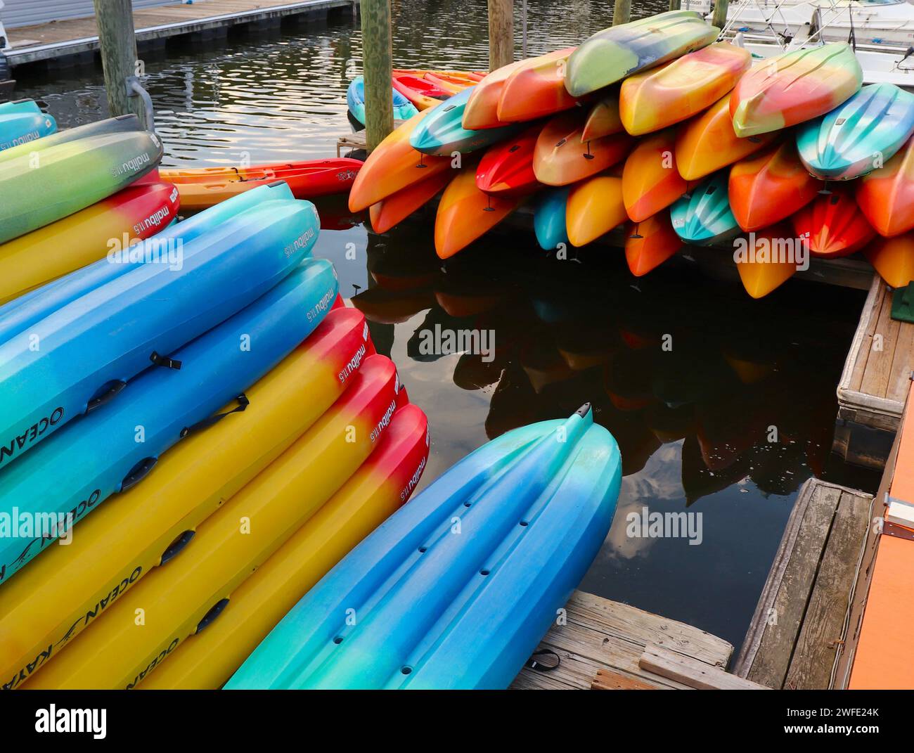 Colorful Kayaks Stacked in Piles by the Water Stock Photo - Alamy