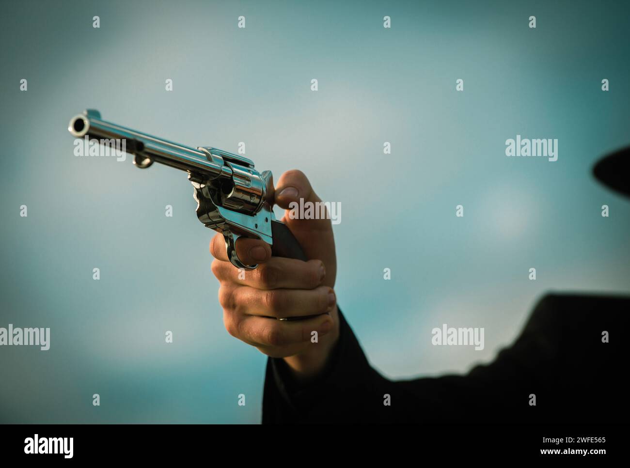Close up shooter hand with guns, vintage pistol revolver. Wild west ...