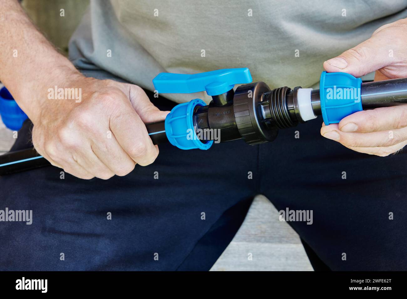 Plumber installing external pipework witch pp pipe compression fittings ...