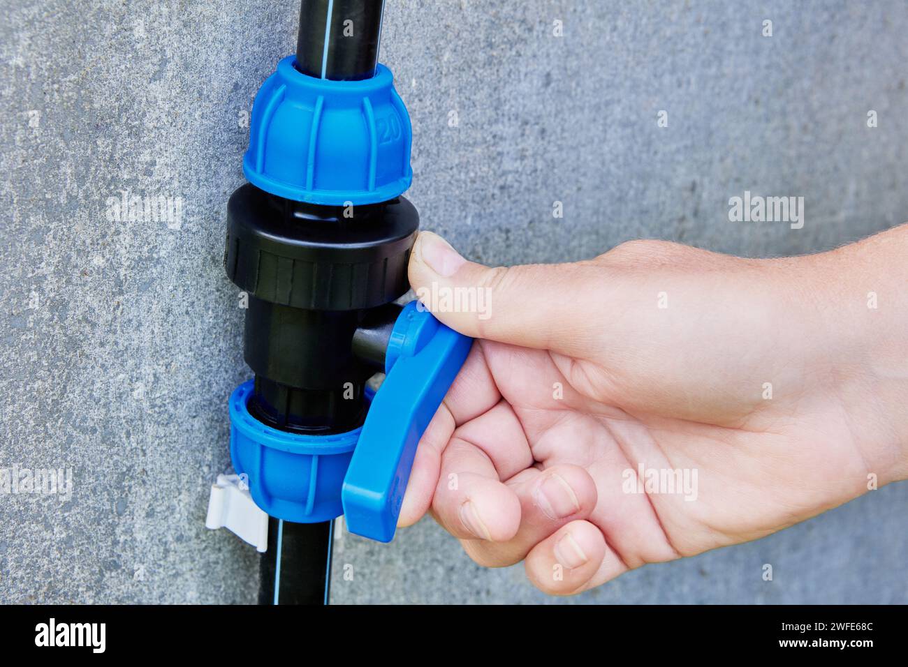 Starting water supply by turning lever in connecting valve fitting of ...