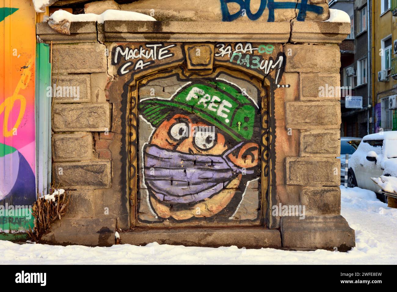 Boy with face mask graffiti street art with Cyrillic text reading Masks ...