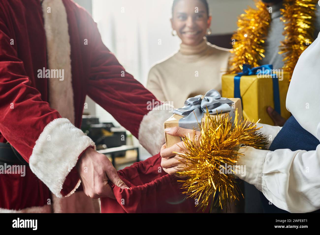 Hands of young pregnant businesswoman taking giftbox with tied grey ...