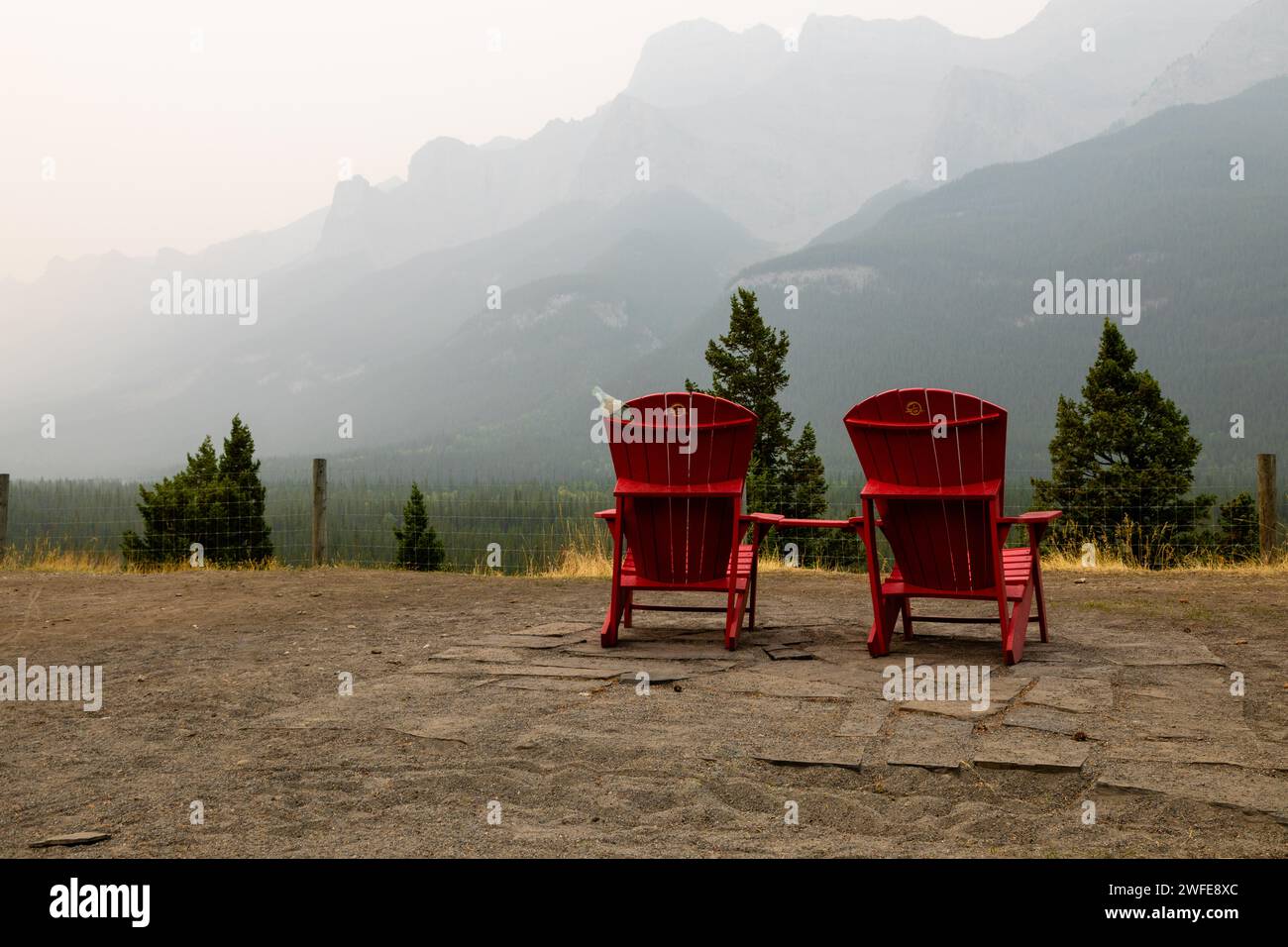 red Adirondack chairs in Banff National Park, Canada with cloudy ...