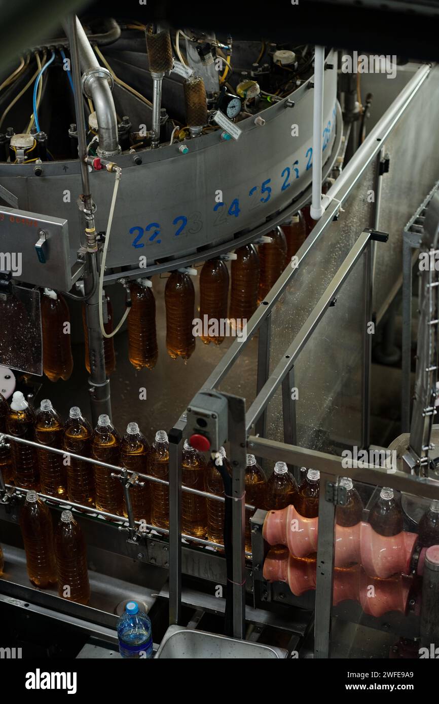 Part of belt conveyor with unpacked transparent plastic bottles ...