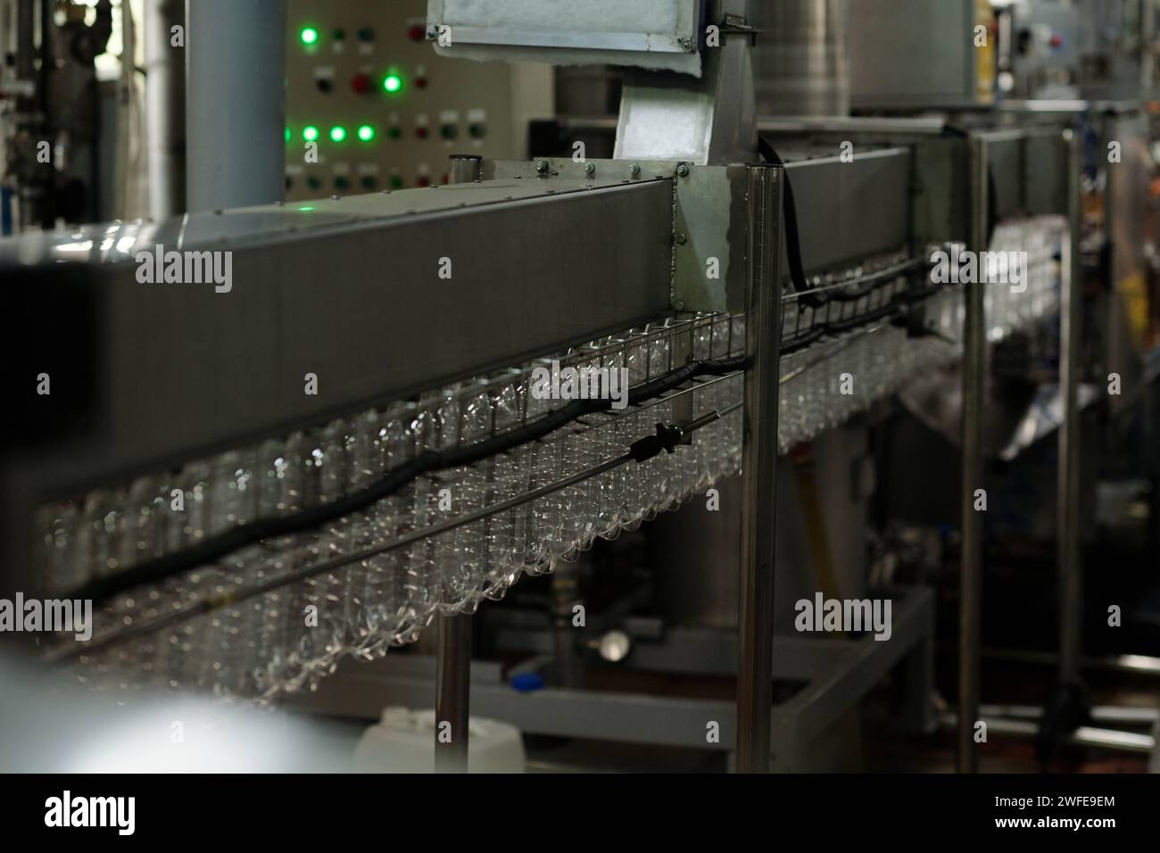 Part of belt conveyor with clean empty transparent plastic bottles ...