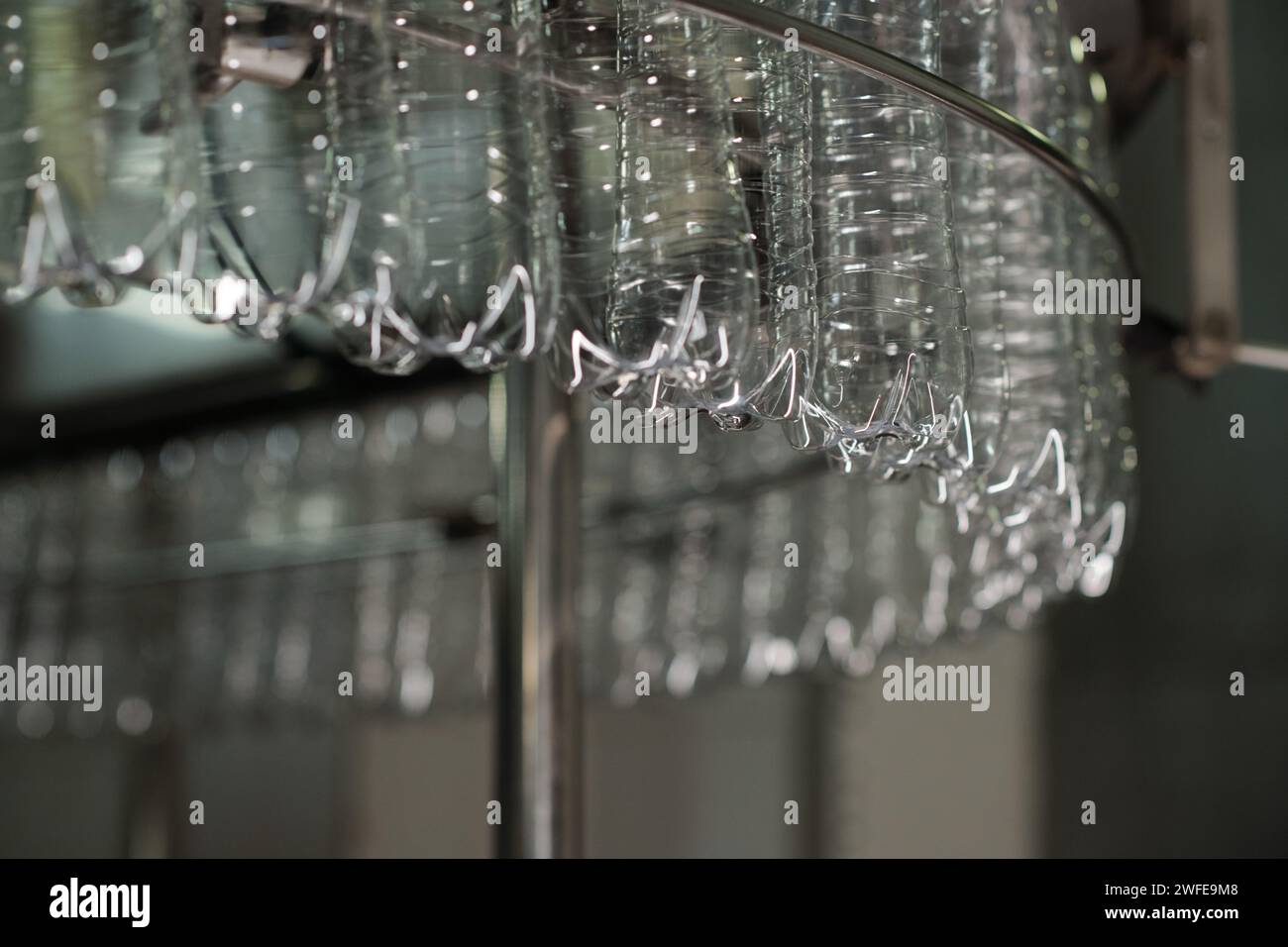 Bottom part of empty clean plastic bottles rotating in huge industrial ...