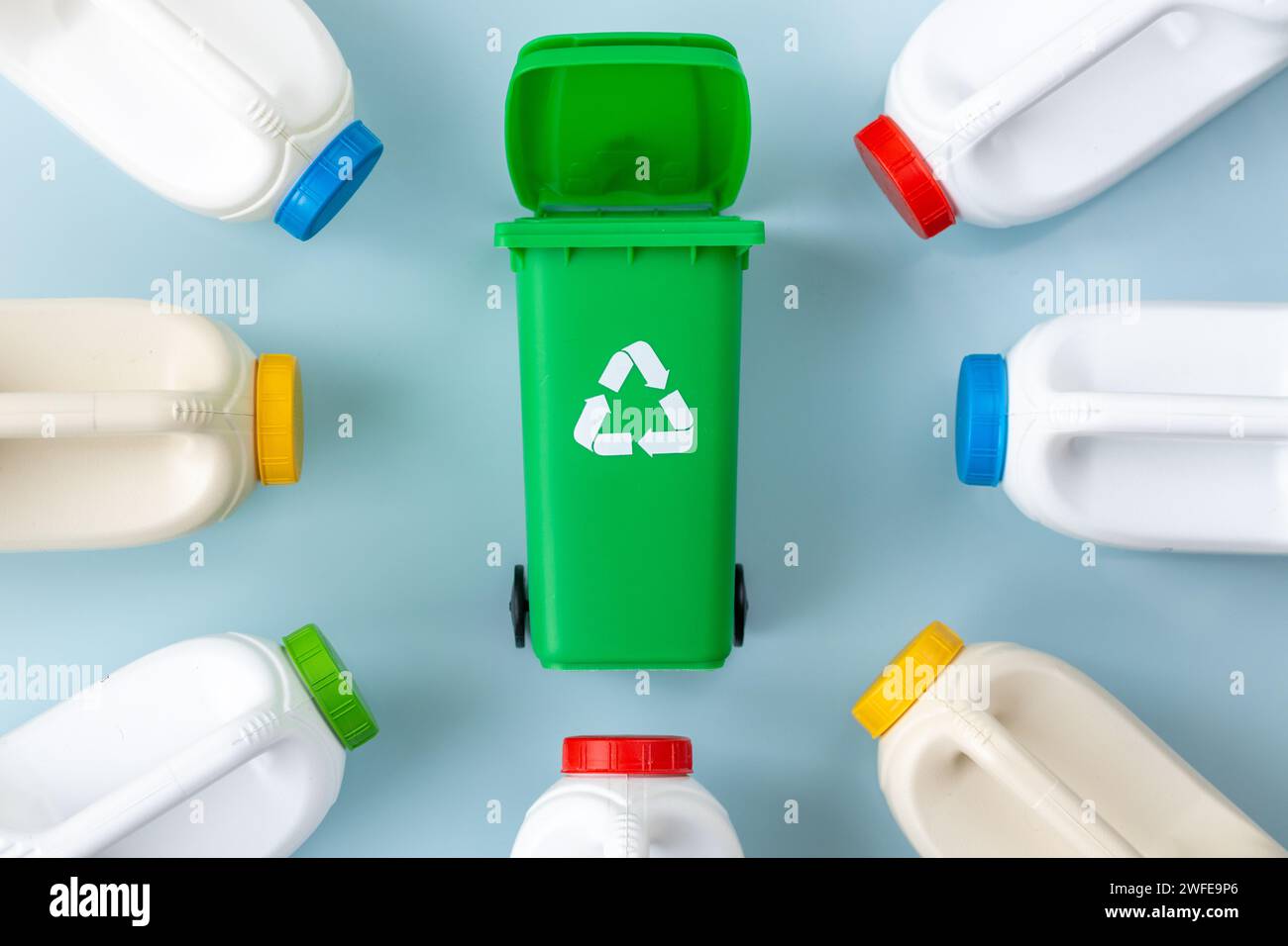 Segregation of plastic waste, green garbage bin and plastic bottles on ...