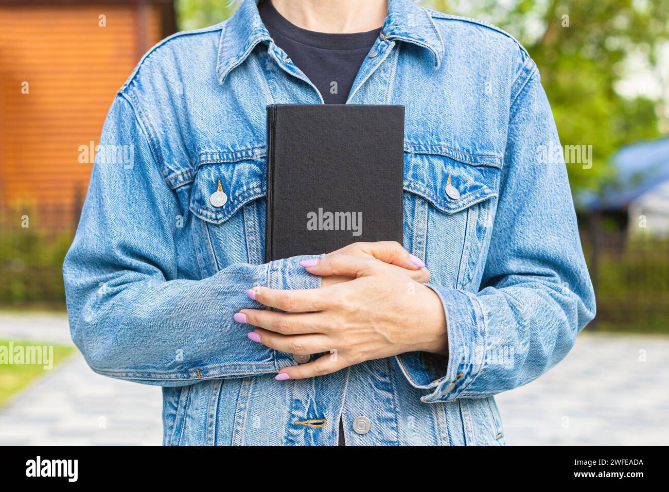 Woman holding paper to chest hi-res stock photography and images - Alamy
