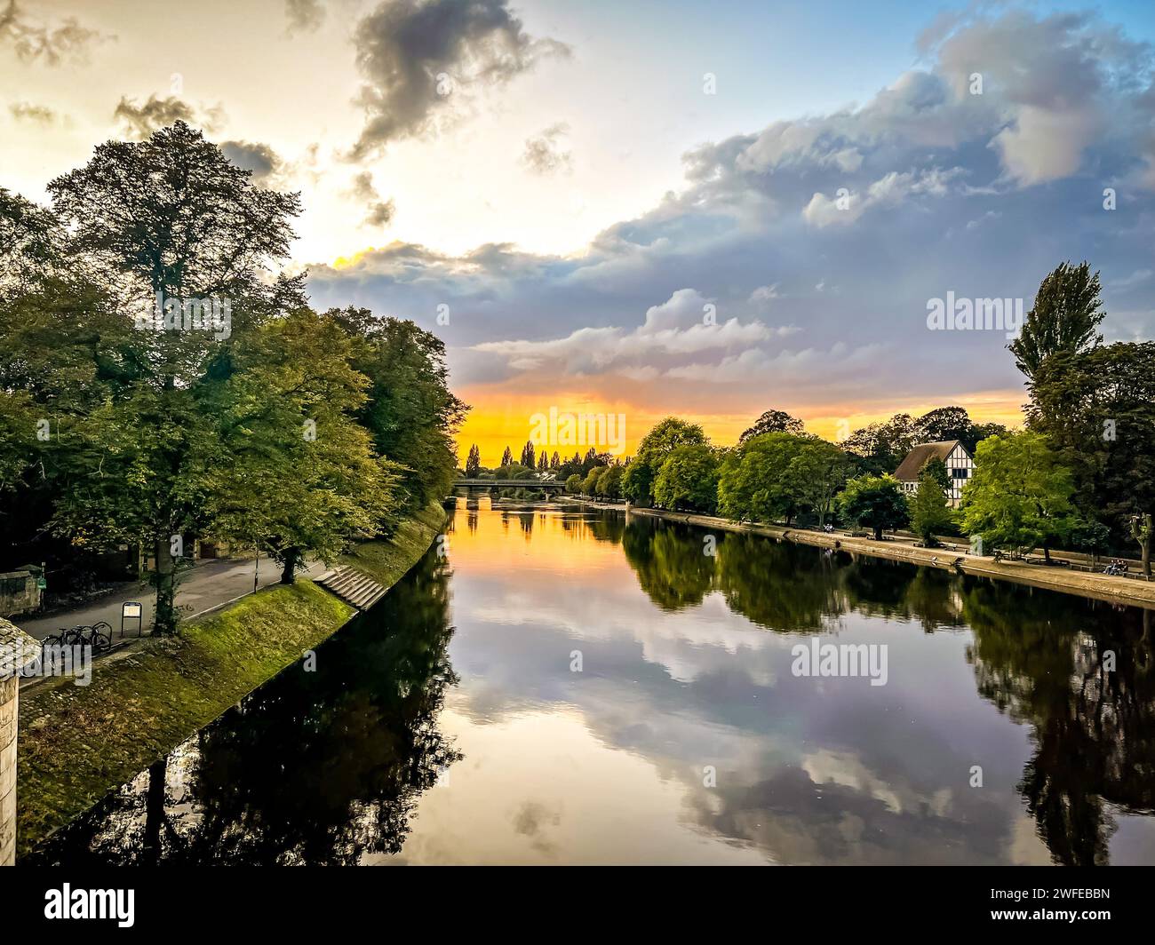 The pretty Clouds over city on river at sunset Stock Photo - Alamy