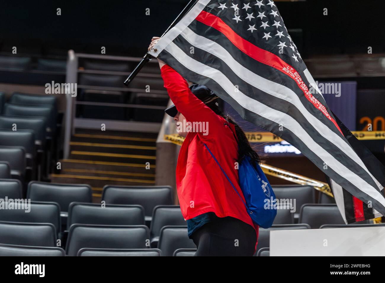 Woman running with Thin Red Line flag at the 8th annual BFit Challenge ...