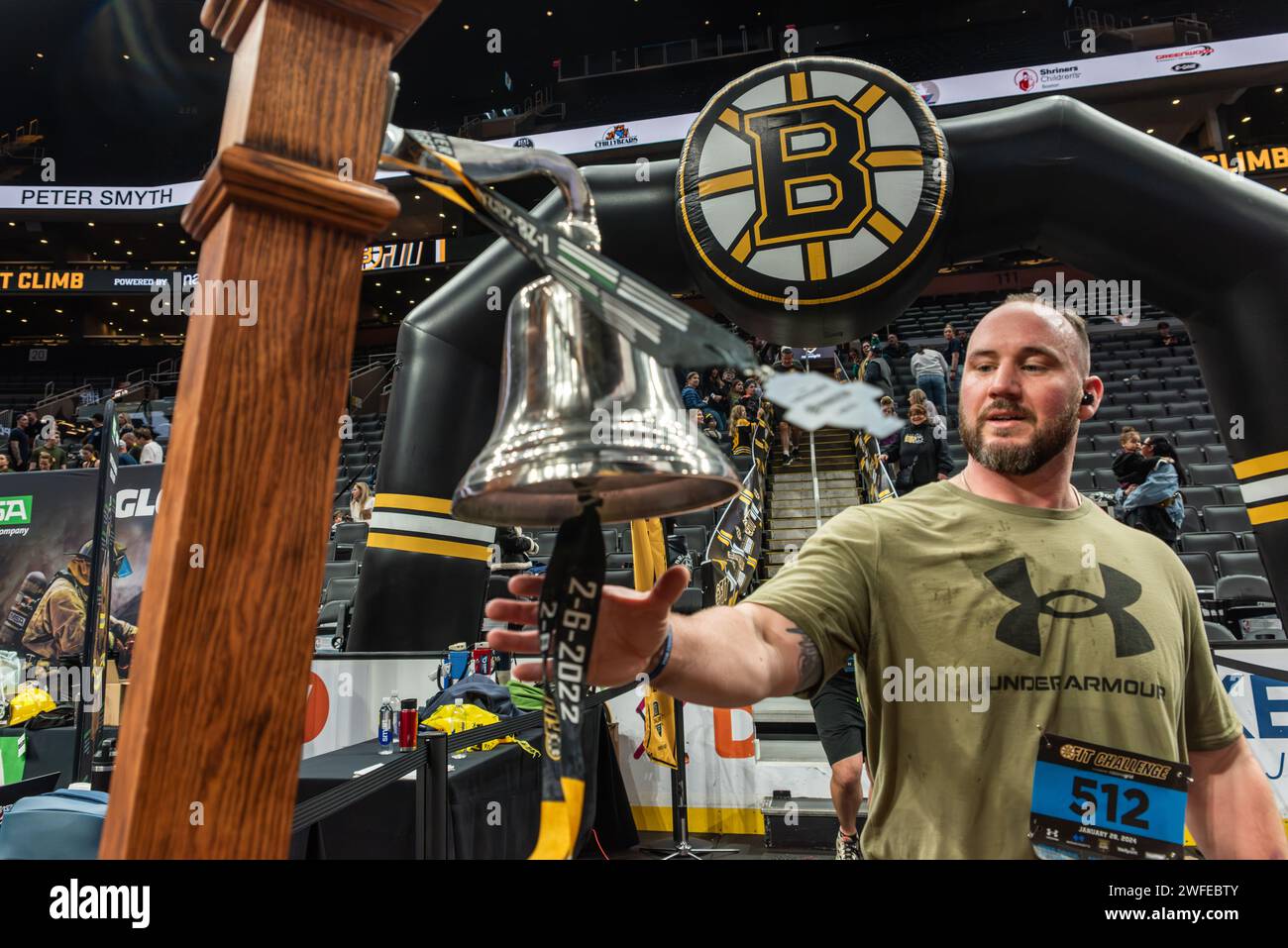 Man ringing bell at the finish line of the 8th annual BFit Challenge ...