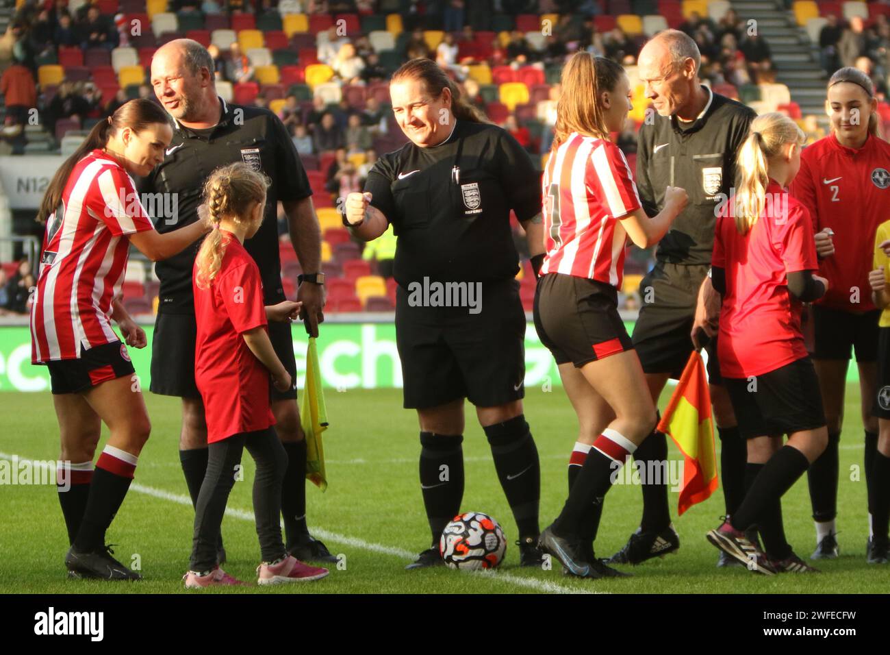 Referee Lucy Clark (centre) shakes hands before Brentford Women v ...