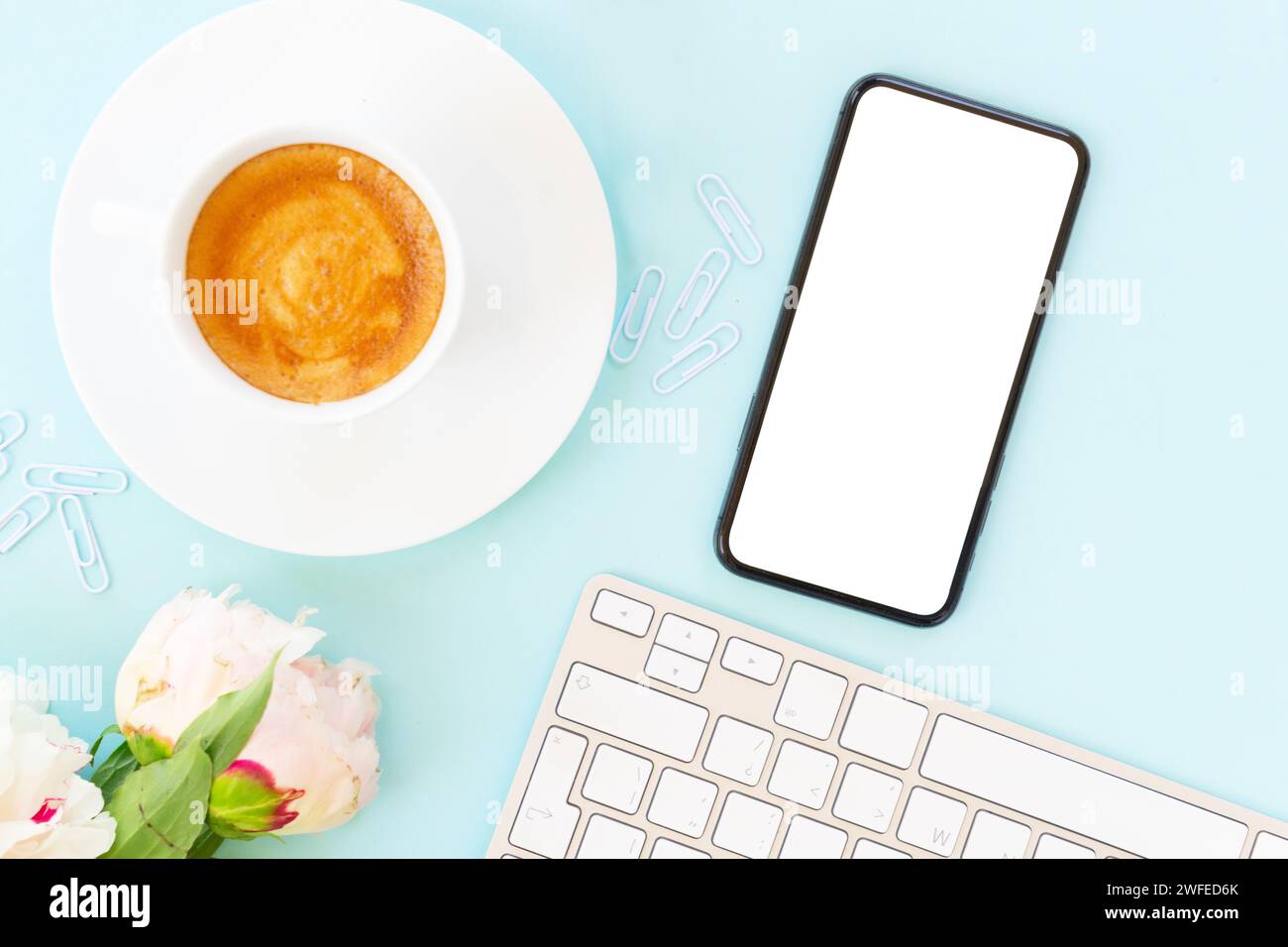 Home office desk with phone on blue Stock Photo - Alamy