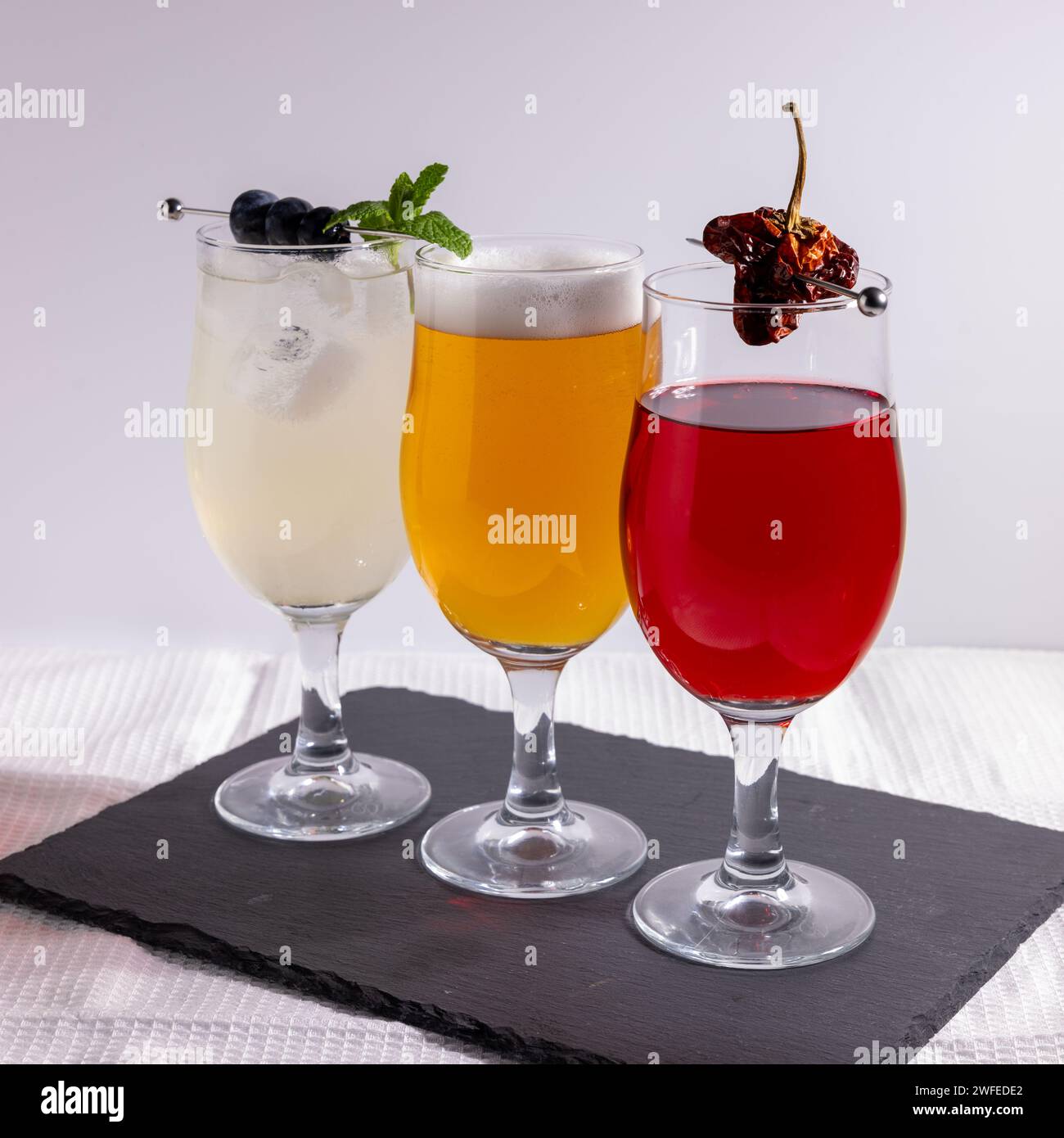 Cocktails and beer prepared and garnish in studio against white ...