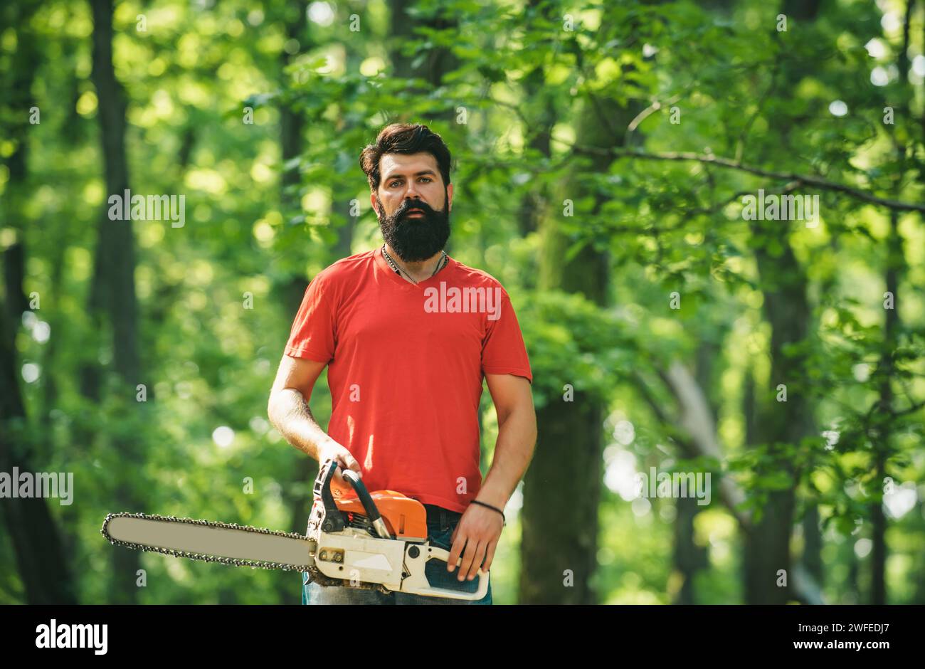 Handsome young man with axe near forest. Lumberjack concept ...