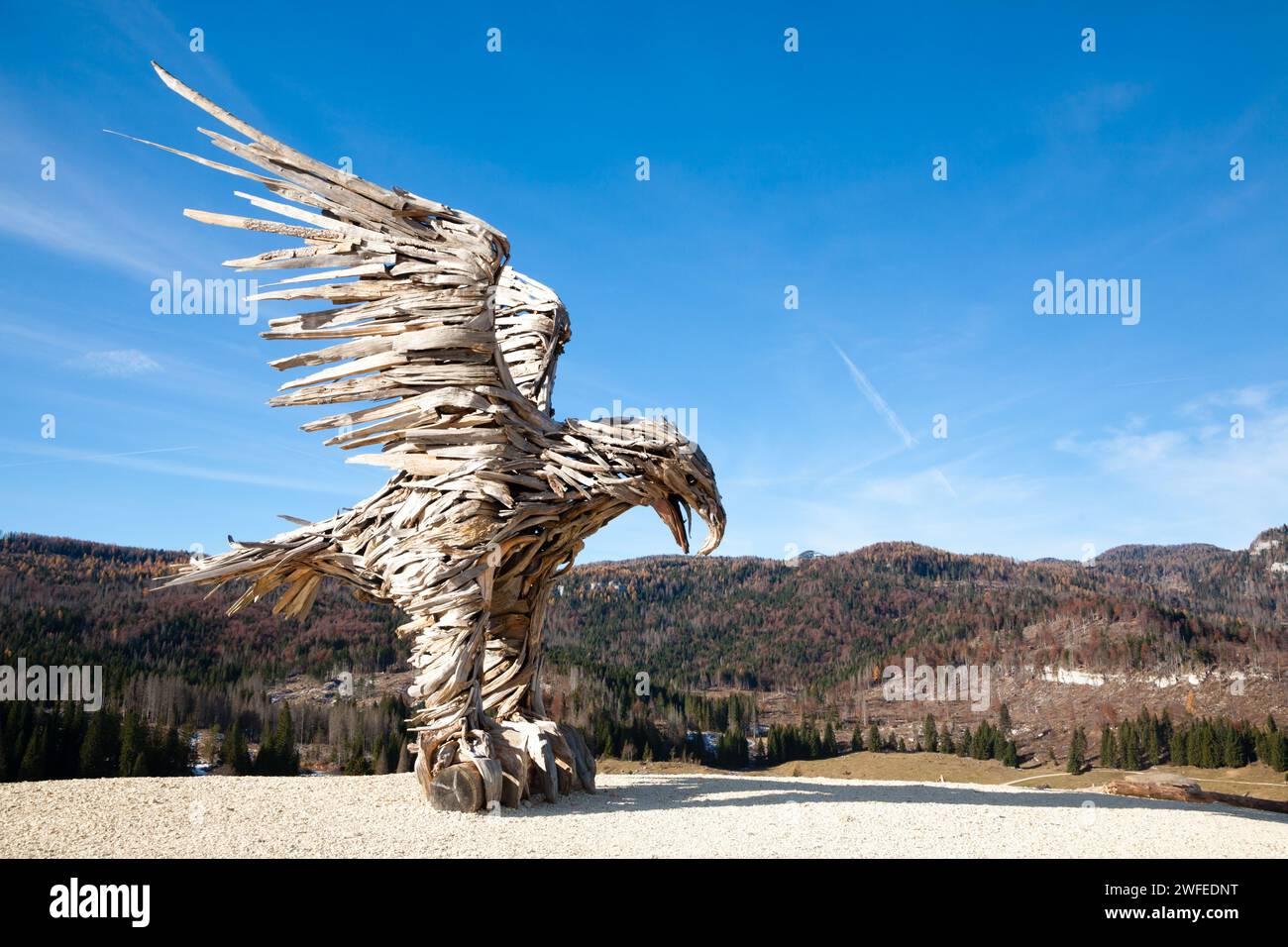 Wooden sculpture of an eagle made of tree branches. Vaia storm eagle ...
